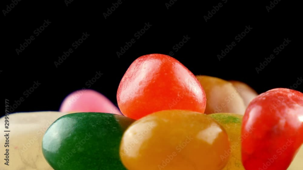 Extreme close up shot of some assorted jelly beans, rotating under a ...