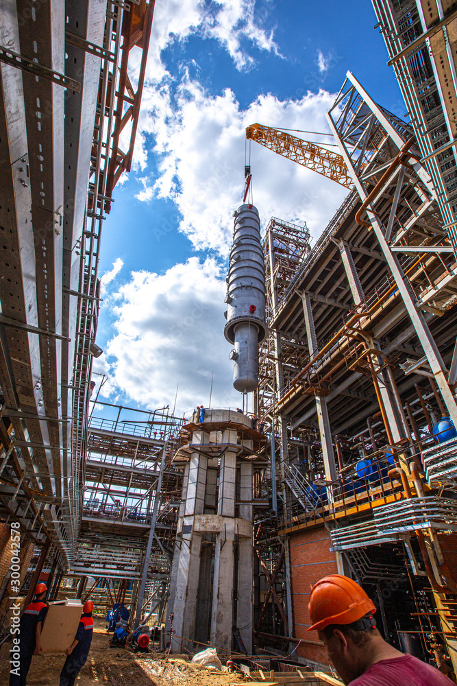 Construction of an oil refinery near Moscow. Workers install components ...