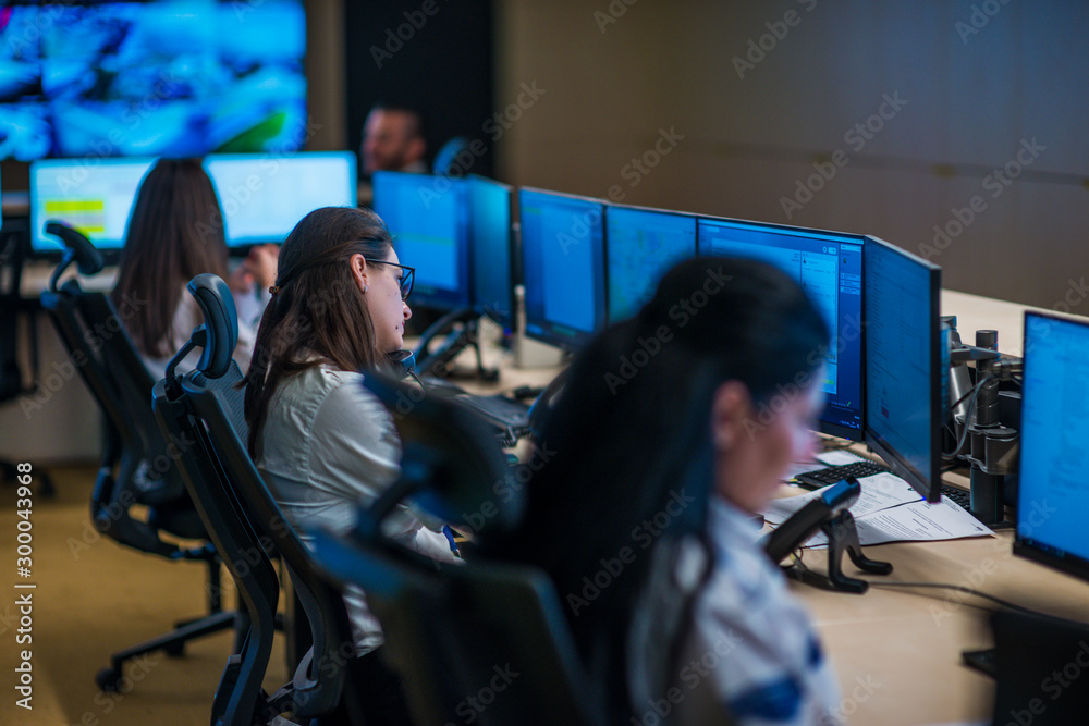 Security guard monitoring modern CCTV cameras in a surveillance room ...