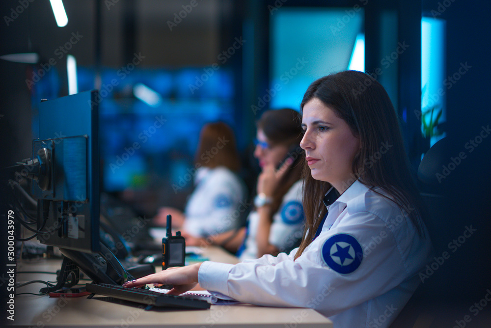 Security guard monitoring modern CCTV cameras in a surveillance room ...