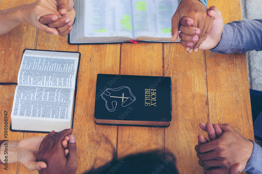 Group of people holding hands praying to God. religious beliefs. Stock ...