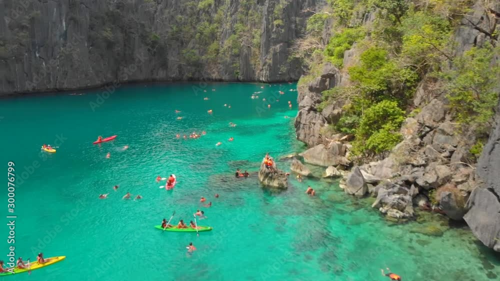 People kayaking in the twin lagoon between the rocks in Coron, Palawan ...