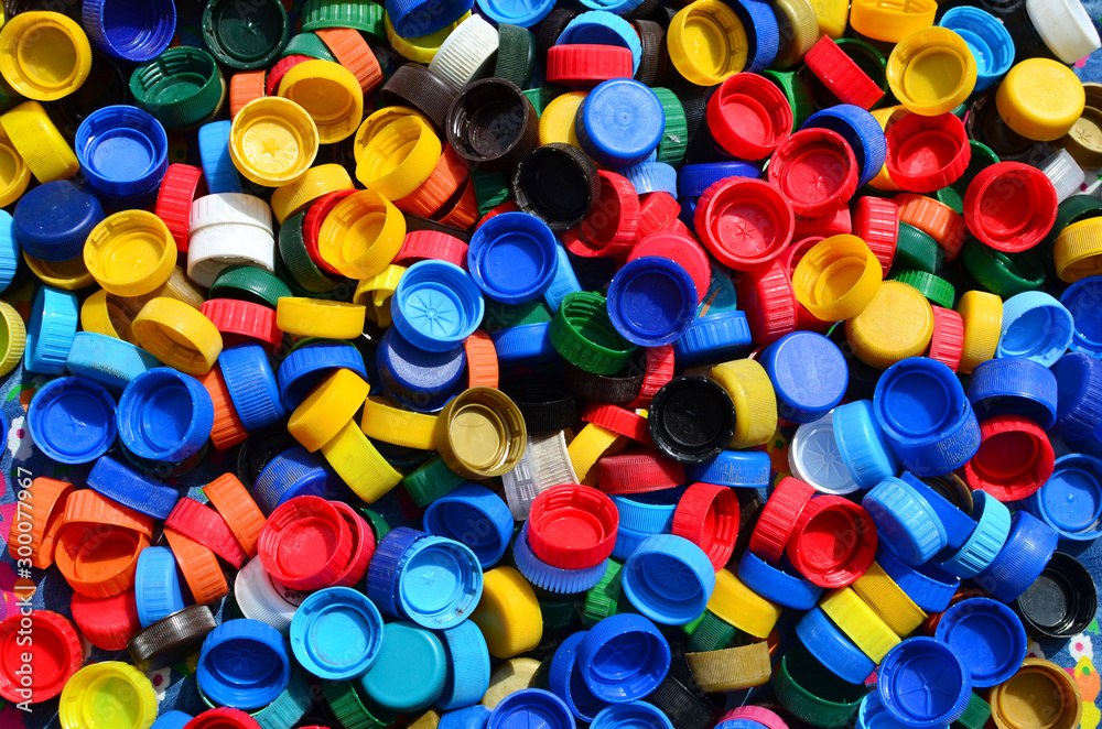 Plastic bottle caps background. Cap material is recyclable.Remove lids ...