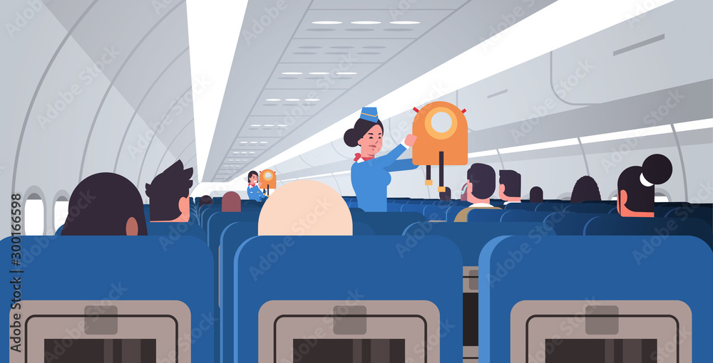 stewardess flight attendant explaining for passengers how to use jacket ...