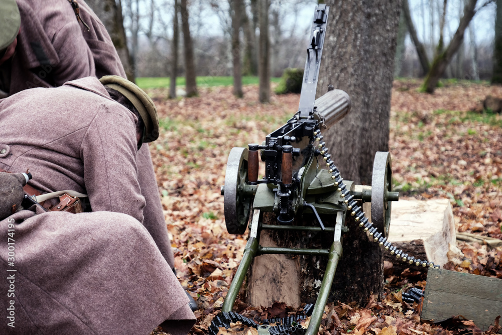 retro machine gun and soldiers in the forest Stock Photo | Adobe Stock