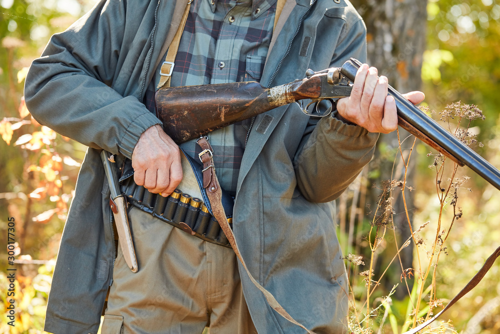 Unrecognizable hunter male loading gun, wearing casual hunting clothes ...