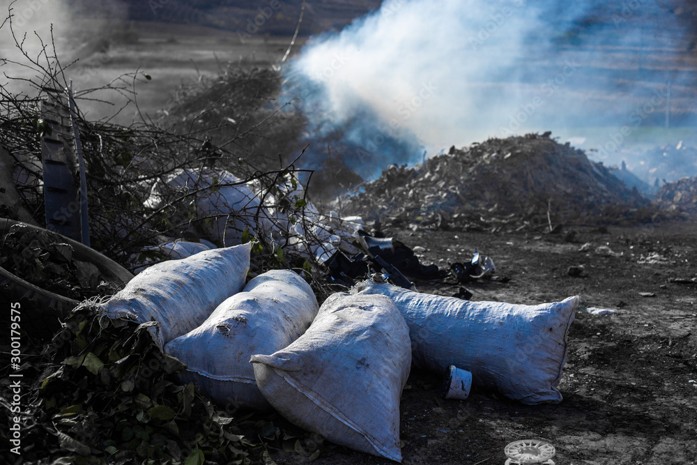 Trash and smoke representing a zone disaster and bad waste management ...