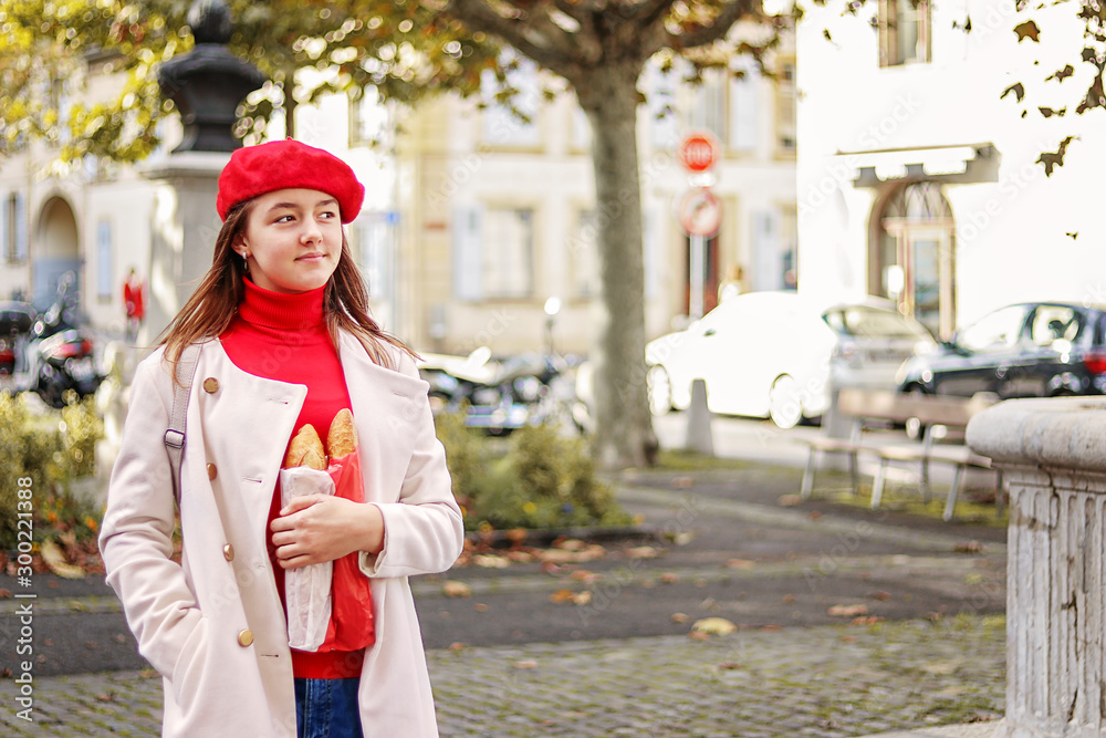 Portrait of happy smiling teenager girl in bright red beret walking in ...