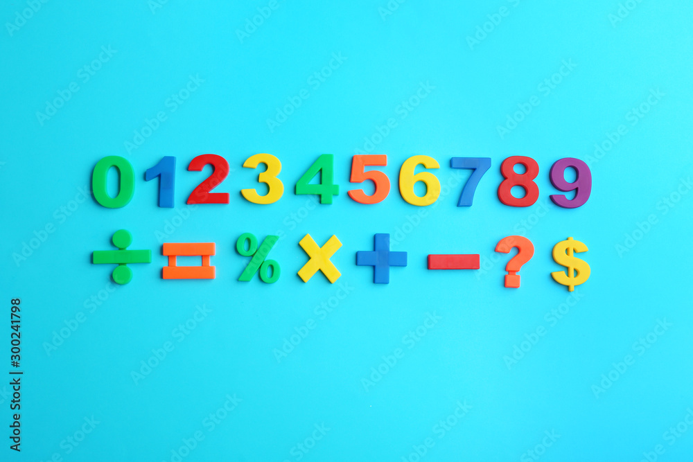 Colorful magnetic numbers and math symbols on light blue background ...