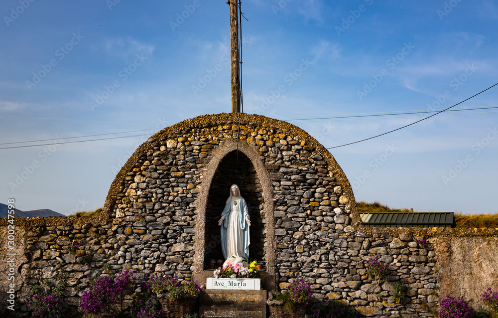 Old roadside shrine of the Virgin Mary in rural Ireland at sunrise ...