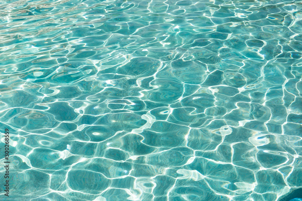 Turquoise blue water in swimming pool background, sun reflection, clear ...