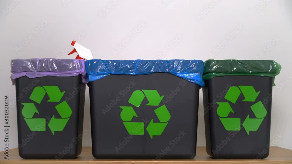 Distribution of waste for recycling at home. A woman's hand puts ...