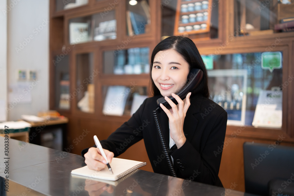 Welcome to the hotel,Happy young Asian woman hotel receptionist worker ...