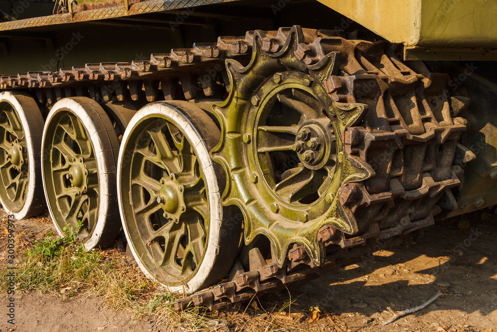 Wheels and tracks of the tank. Military equipment background. Close-up ...