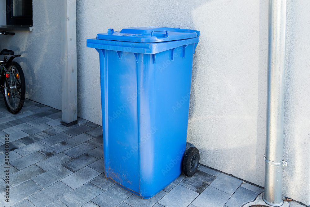 Blue plastic trash can in Europe. Household trash, storage on the ...