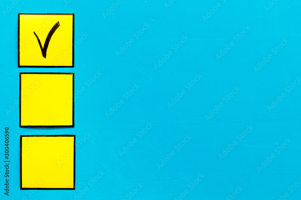 Check mark in yellow check-box on blue background top view space for ...