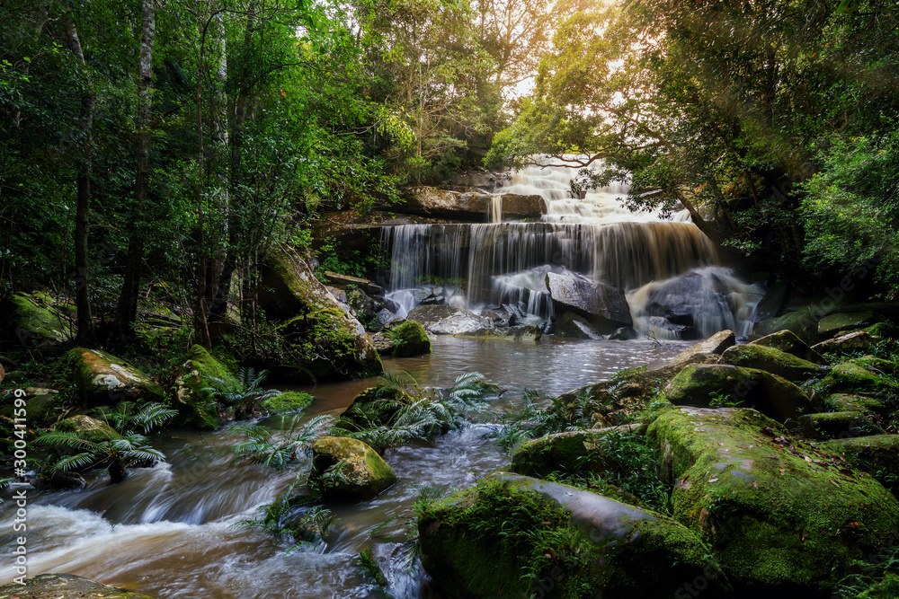 Phonpob waterfall, a beautiful waterfall in a forest filled with green ...