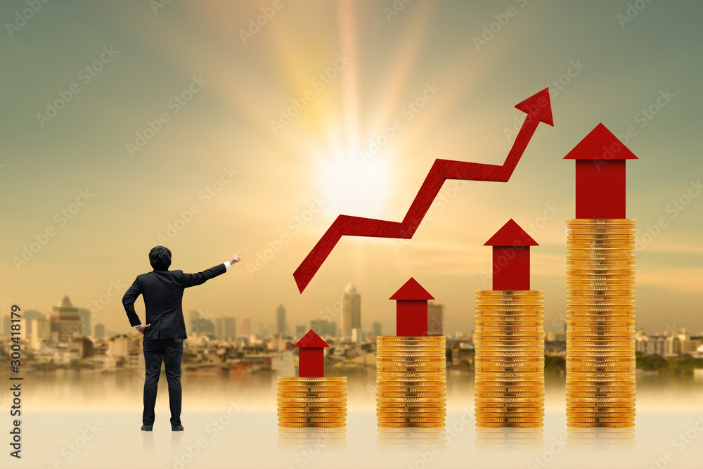 Businessman is introducing a investment as a stack gold coin and red ...