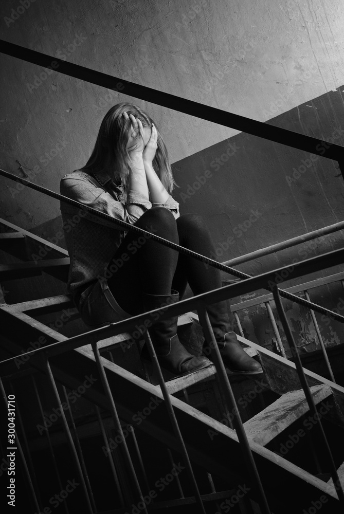 Despair, sadness and loneliness of a person sitting in the dark, crying ...