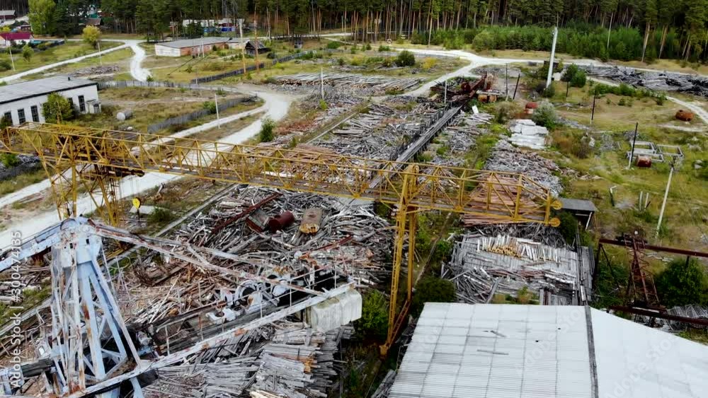 Aerial flight over old sawmill in Russia. Timber-works carelessly ...