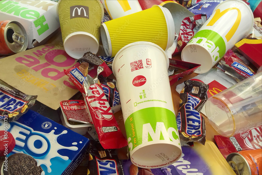 Many used food wrappings and drink cans by random food manufacturing ...