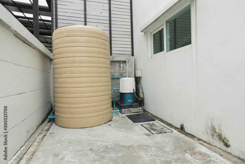 New water tank with water pump installed at the back of the house ...