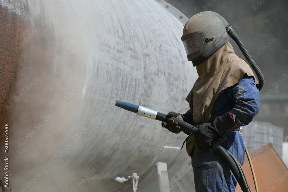 engineer sandblasting a steel casing Stock Photo | Adobe Stock