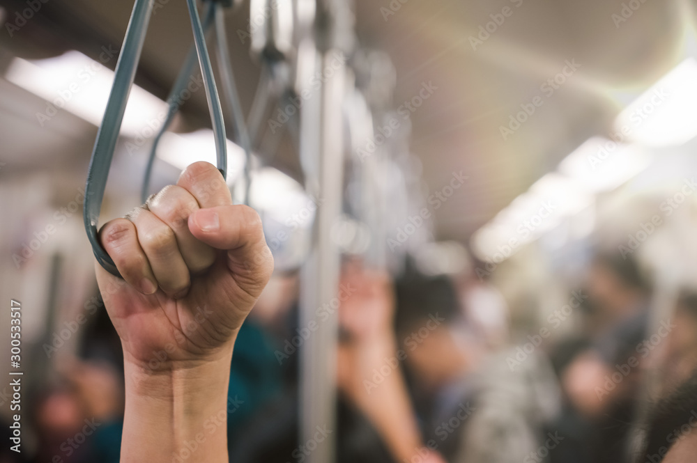 young passenger woman hand holding Handle on the train or on the bus ...