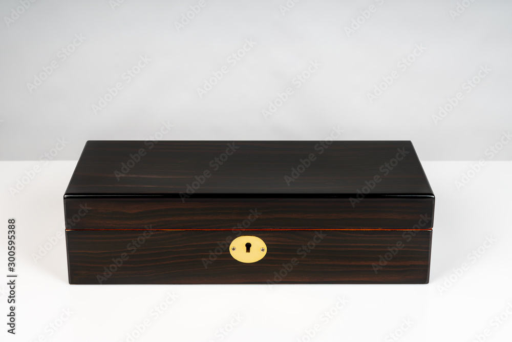 Closed dark brown wooden luxury jewelry watch case box with lid on ...