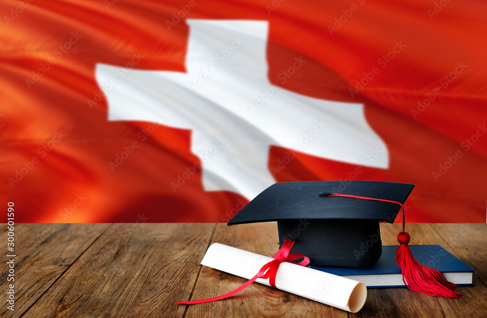 Switzerland education concept. Graduation cap and diploma on wooden ...