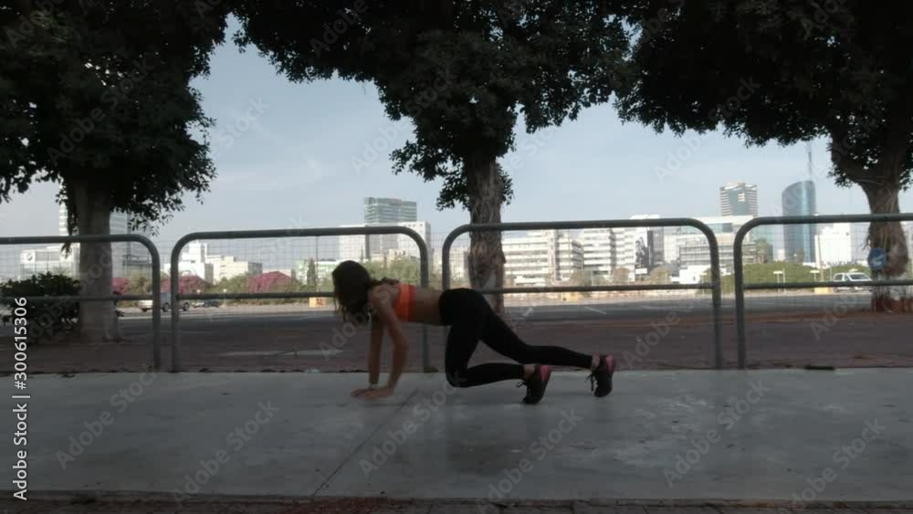 Thin muscular woman walking on all fours like a bear, as part of her ...