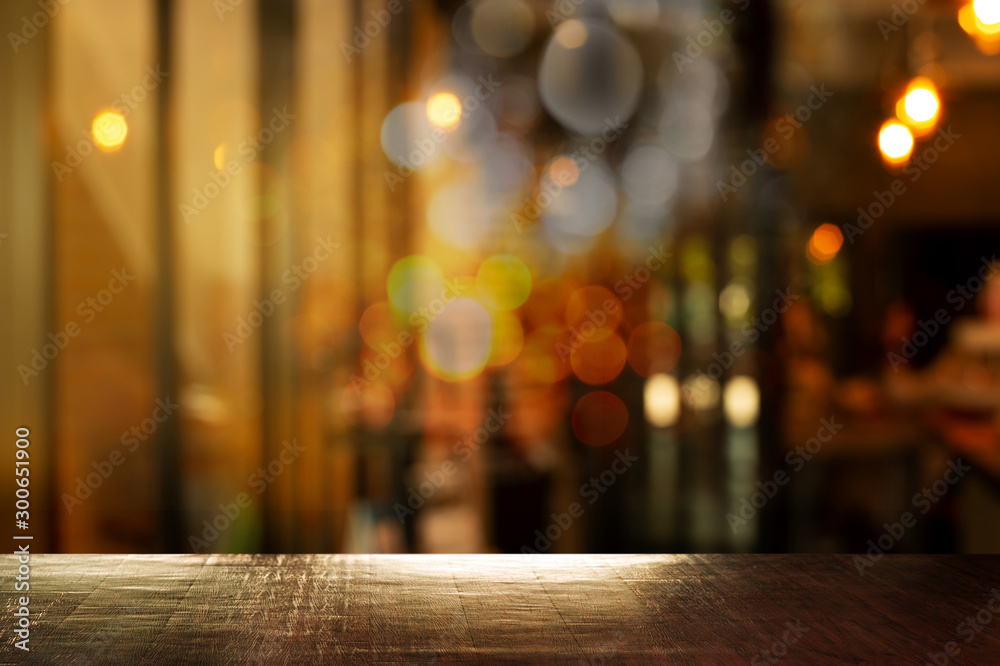 top of brown wood table with blur party bokeh light in bar or pub dark ...