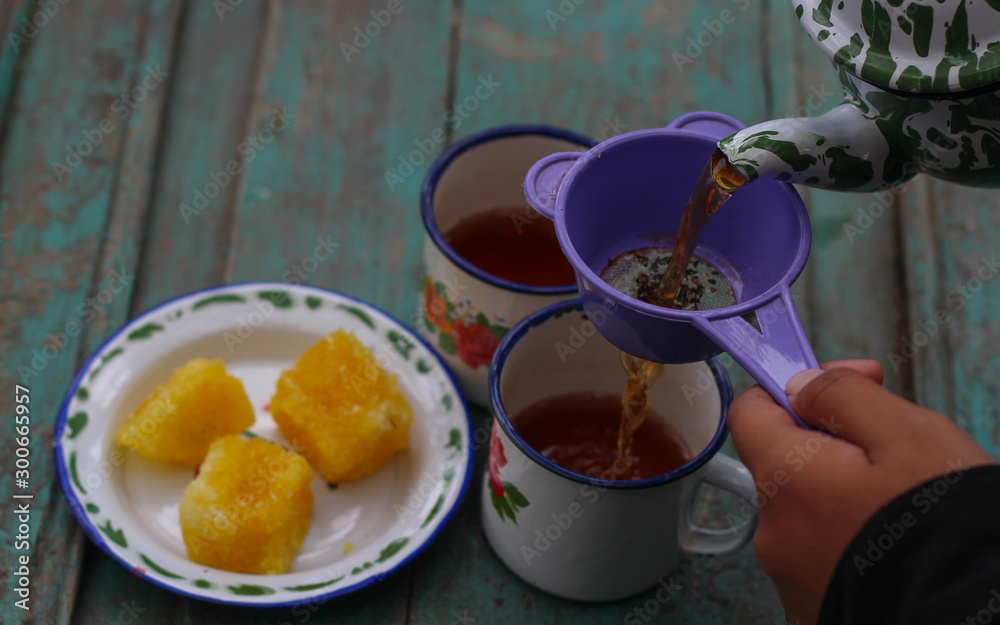 cup of traditional tea from Indonesia called "poci tea" with Rock sugar ...