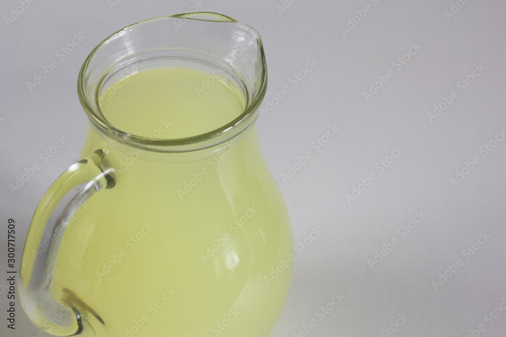 Liquid whey that remains after formation of curds in jar on white ...