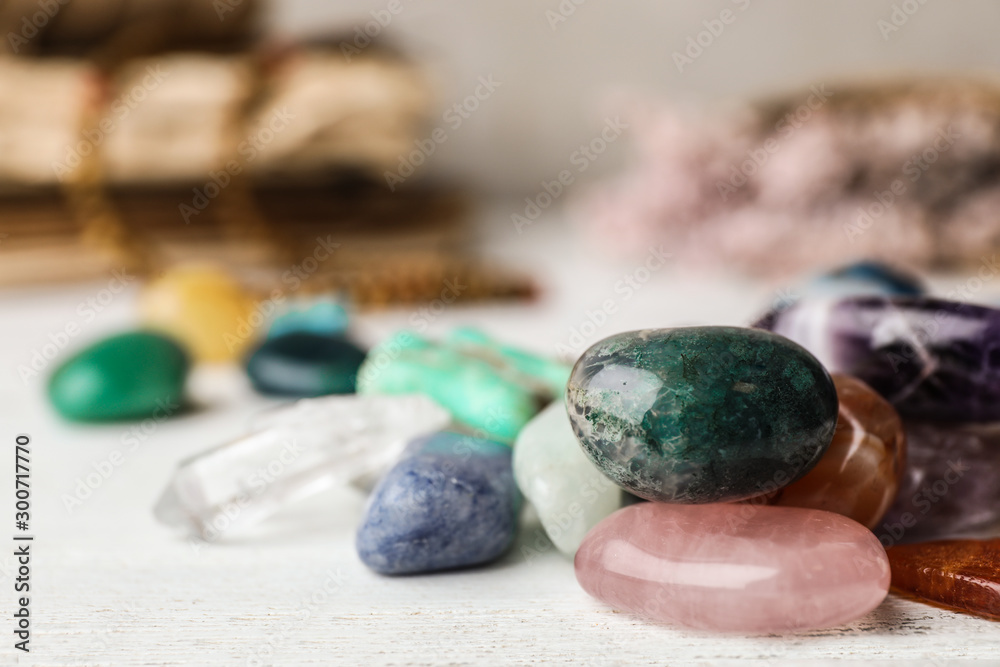 Pile of different gemstones on white wooden table. Space for text Stock ...