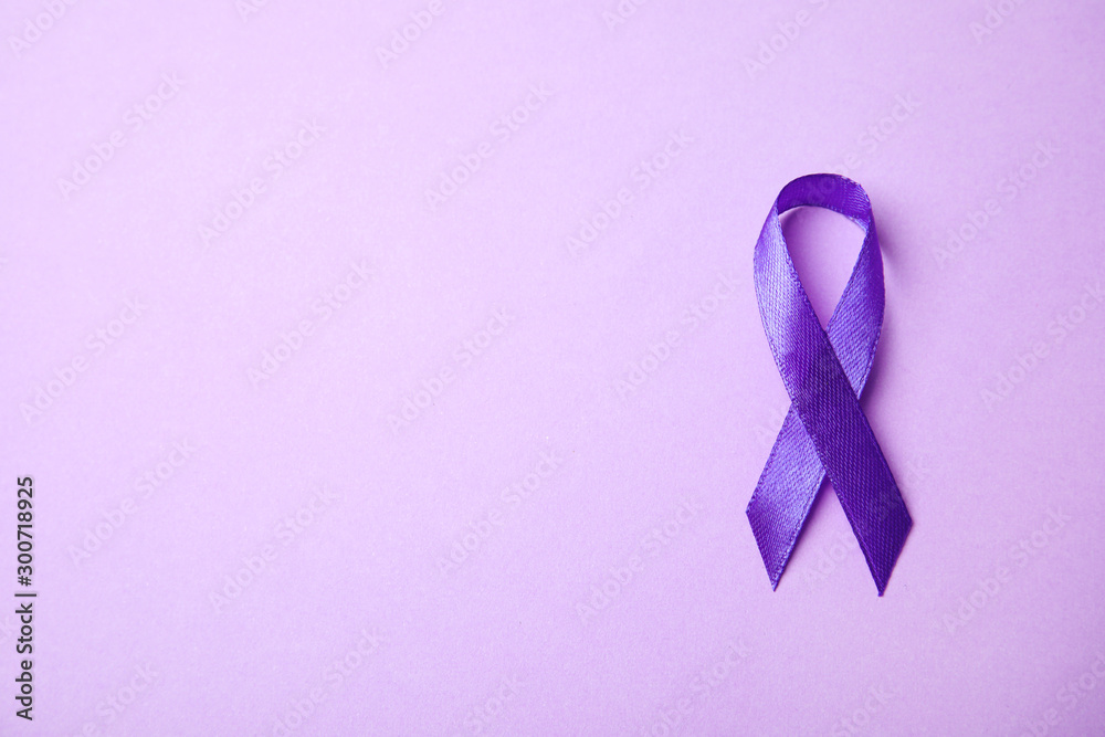 Purple ribbon on lilac background, top view with space for text ...