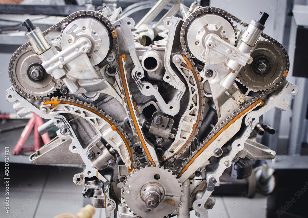 Parts of a disassembled car engine organised on the table for the ...