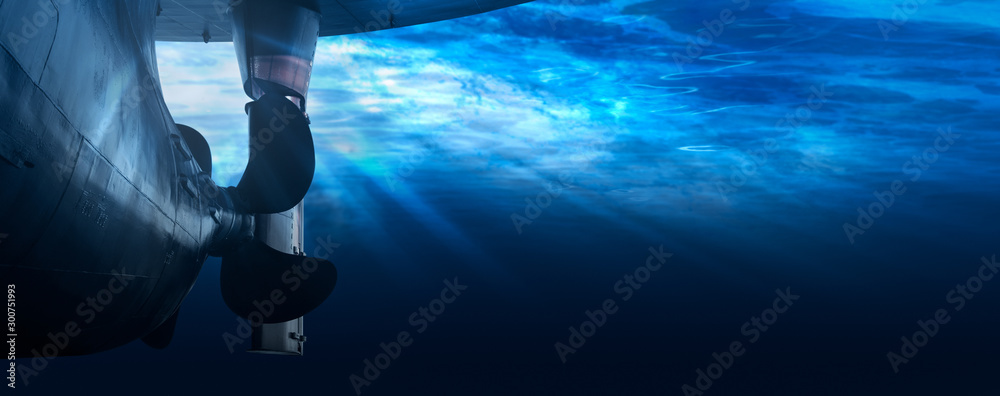 Propeller and rudder of big ship underway from underwater. Close up ...