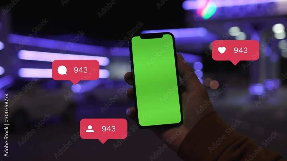 Hands holding use smartphone with vertical green screen on night city light background car ...