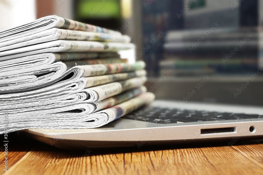 Newspapers and Laptop. Different Concepts for News - Social Network or ...