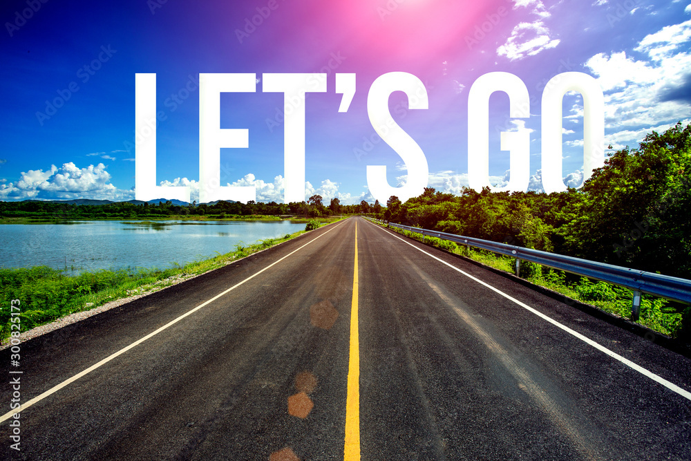 The word Let's go behind the tree of empty asphalt road at golden ...