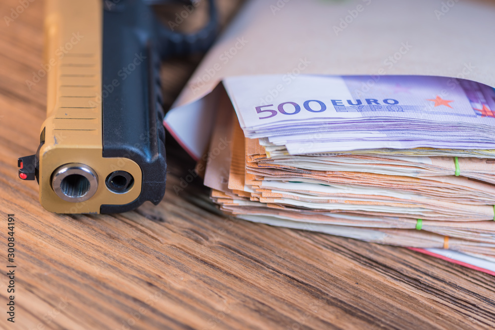 Black and gold gun pistol and money euros background Stock Photo ...