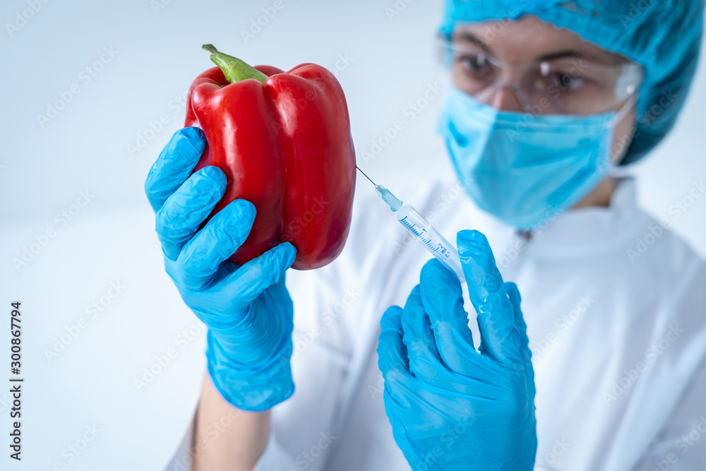 Chemist woman making laboratory analysis, holding syringe in hands ...