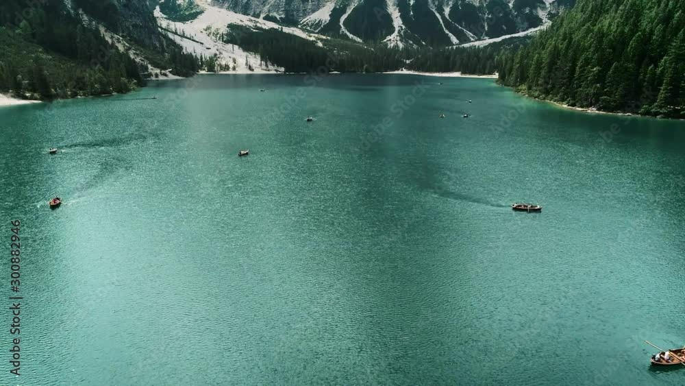 Rowing boats floating on a famous alpine lake Lago di Braies. Tourism ...
