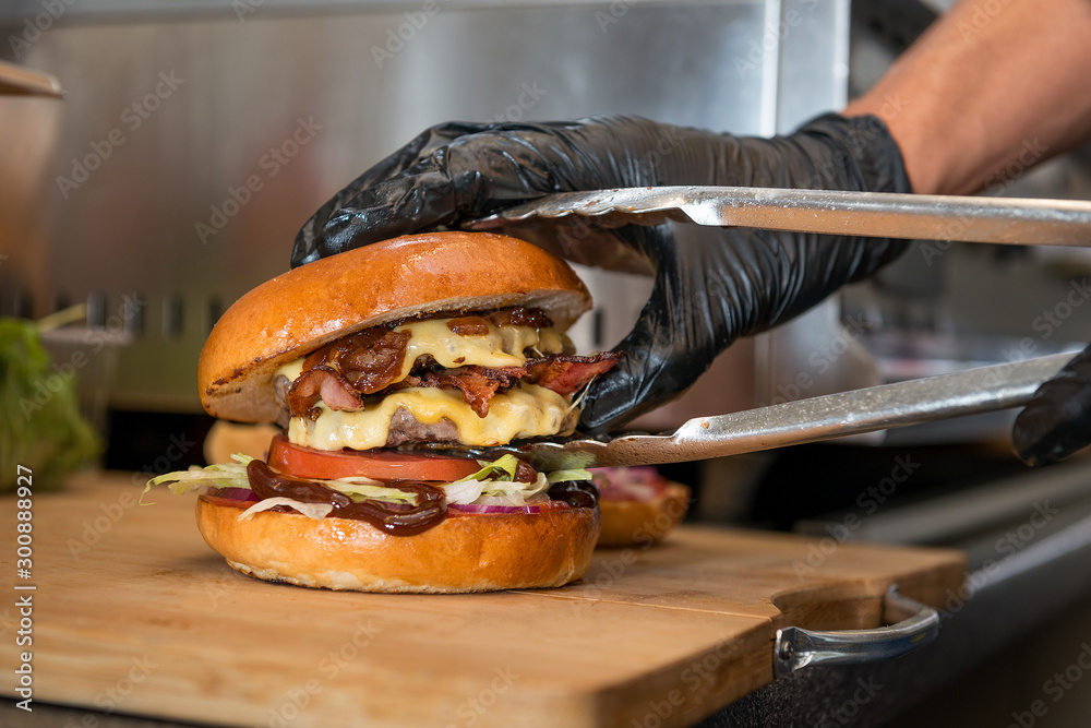 Preparation of burger. Street food. Professional chef is preparing ...