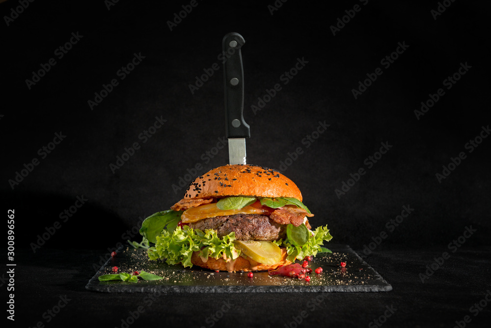 Delicious hamburger on black background. For fast food restaurant ...