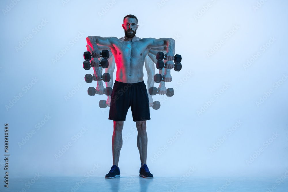 Possibility. Young caucasian bodybuilder training over studio ...