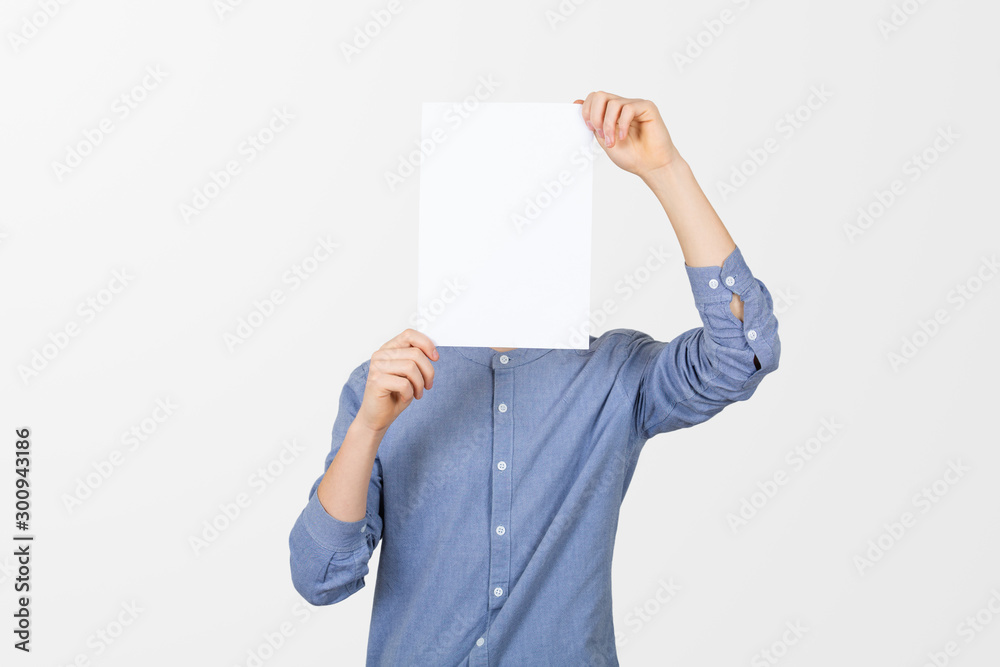 Teenage boy holding blank sheet of paper infront of his face. Man ...