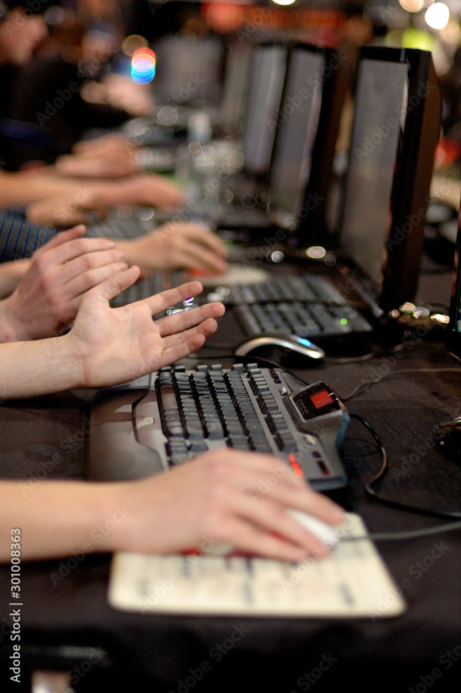 gamers competing in cyber games using computers, gaming consoles and ...