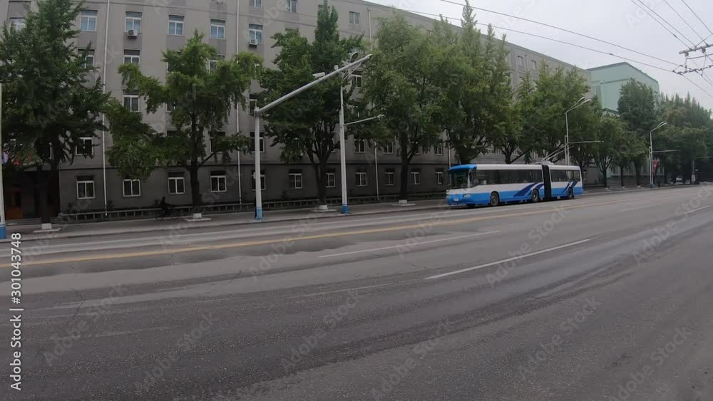 Public bus travelling along Sungri Street and stopping at an ...